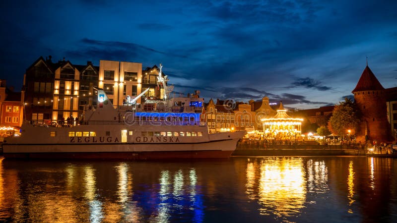 Night View at the Old Town of Gdansk with Carousel and Ship. Editorial ...