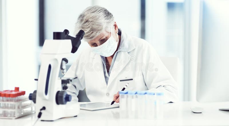 Geared Up the Medical Way. a Focused Elderly Female Scientist Working ...