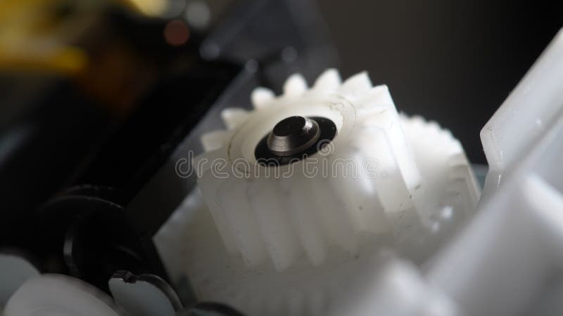 Gears Rotating in Mechanical Device. Machine White Plastic Gears ...