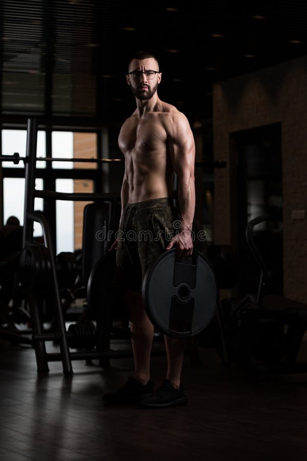Geek Bodybuilder Holding Weights in Hand Stock Image - Image of muscle ...