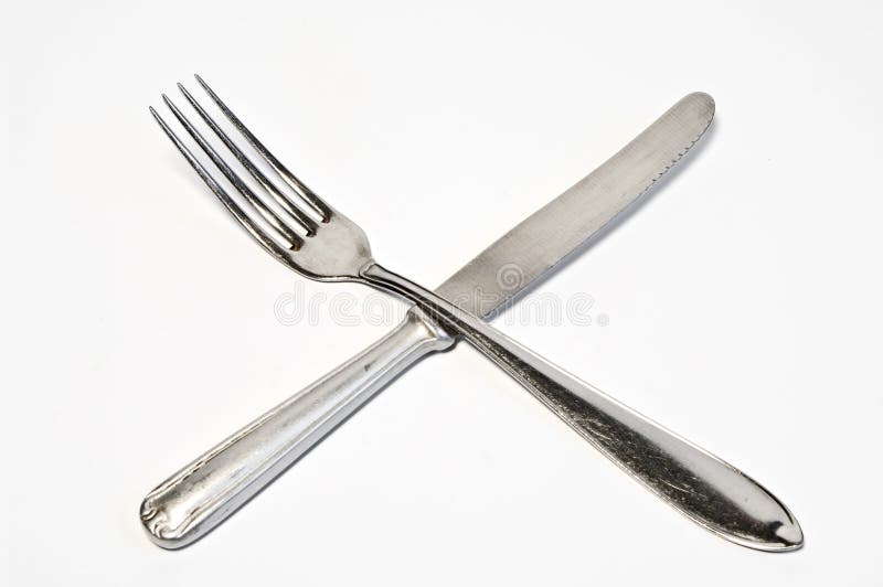 Gekreuzte Gabel und Messer stockfoto. Bild von metall - 12138456