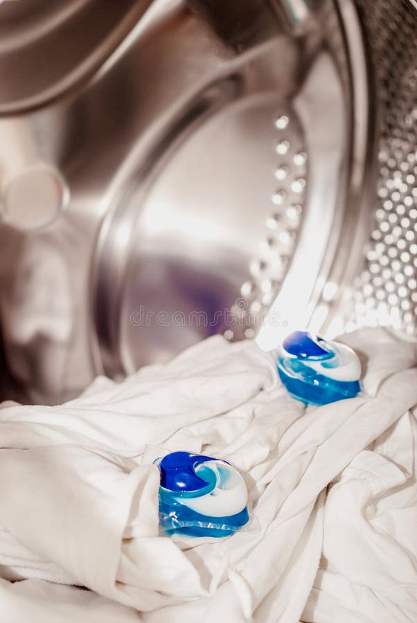 Laundry Blue Capsule in a Washing Machine Stock Photo - Image of disc ...