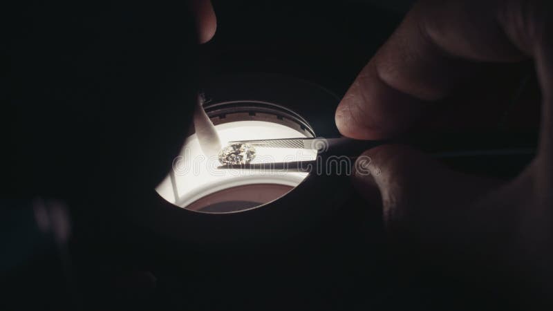 A Gemologist Inspecting a Large Diamond Under a Microscope Stock ...