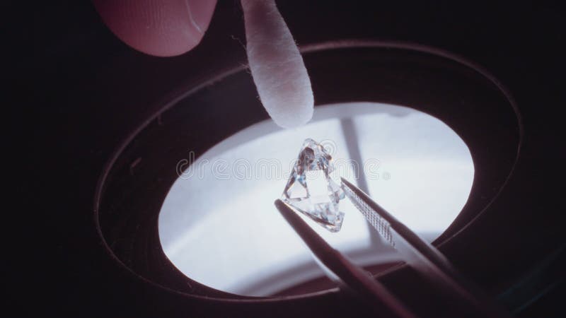A Gemologist Inspecting a Large Diamond Under a Microscope Stock Video ...