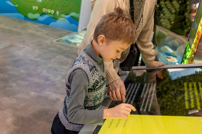 Gen Alpha Boy Interacts with an Interactive Screen, Exploring and ...