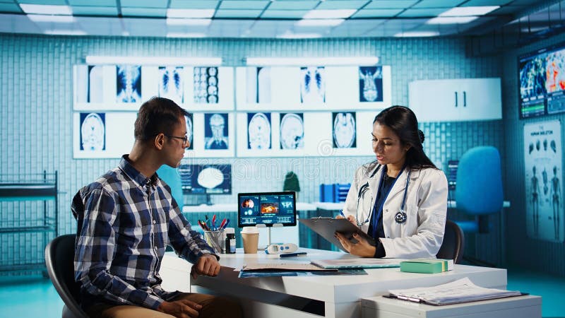 General Practitioner Consulting Patient and Reviewing X Ray Test ...