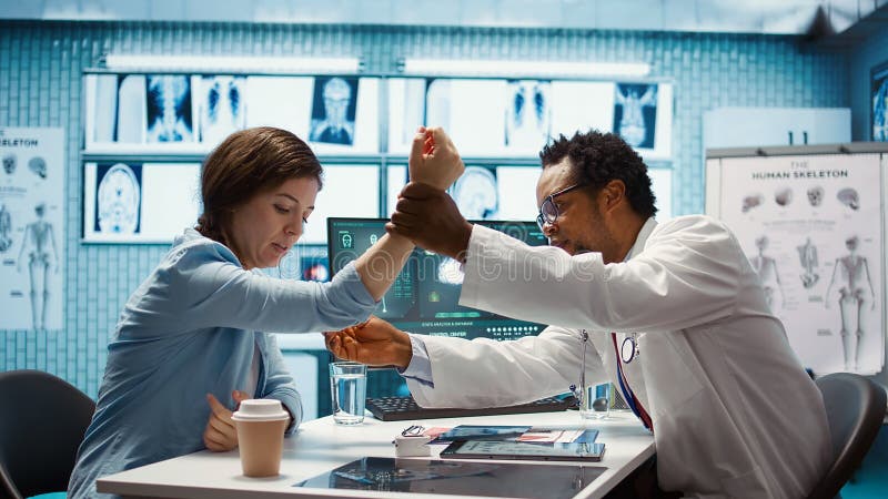 General Practitioner Examining X Ray Scan Test Results with Patient ...