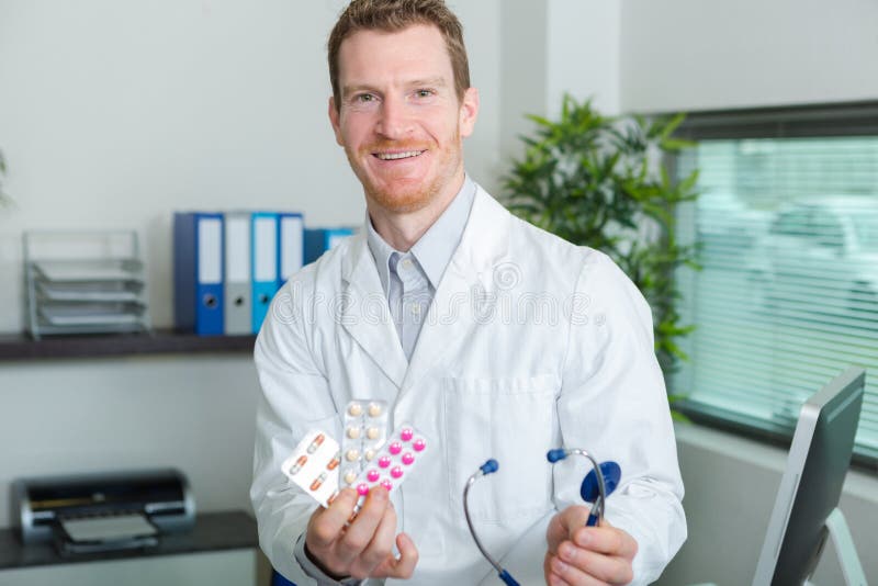 General Practitioner Holding Stethoscope and Medication Stock Photo ...