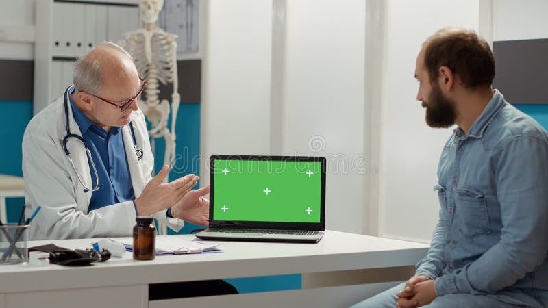 General Practitioner Pointing at Laptop Display with Greenscreen Stock ...