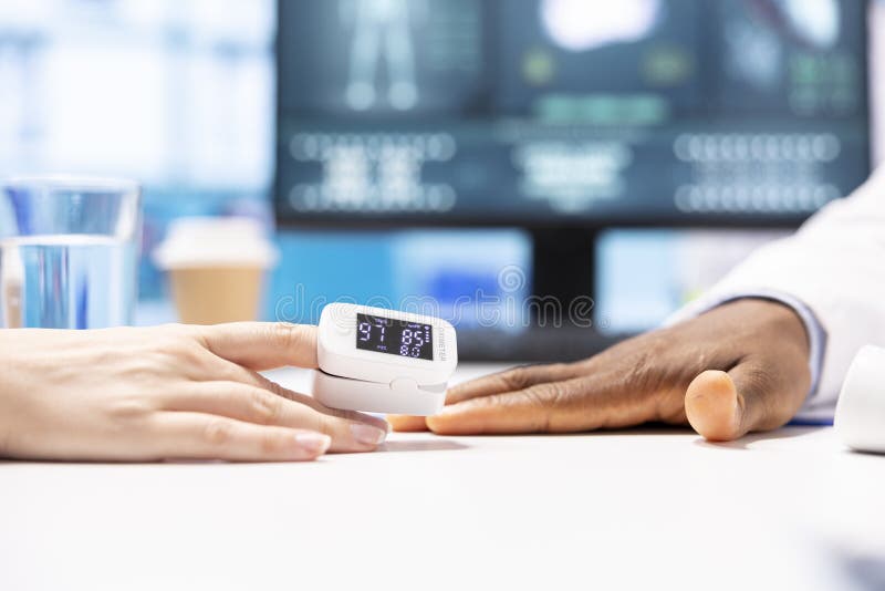 General Practitioner Taking the Oxygen Saturation and Vital Signs for a ...