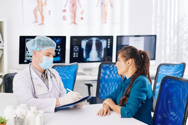 General Practitioner Talking To Patient Stock Photo - Image of covid19 ...