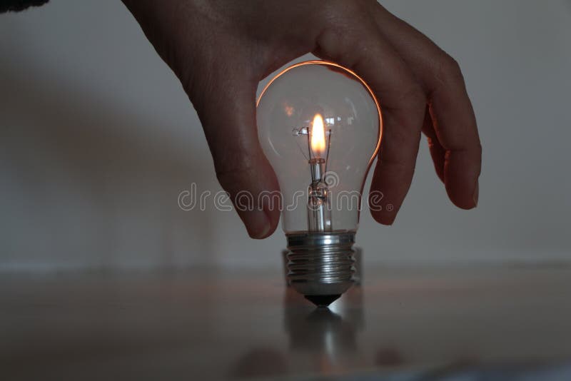 General View of Hand, Light Bulb and Candlelight. Stock Image - Image ...