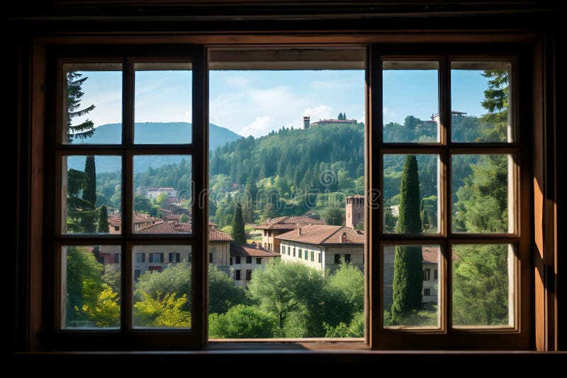 A View Out a Window of a Building with Mountains in the Background ...