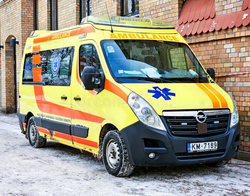 Yellow and Red Emergency Ambulance on the Streets of the City of Riga ...