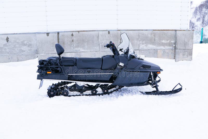 Skidoos Parking in Snow-white Yard. Black Snowmobile Ski-doo Stock ...
