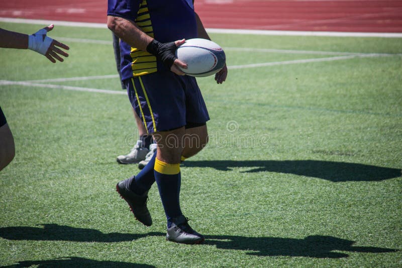 Group of Men Playing Rugby on Grass Field. Stock Image - Image of ...