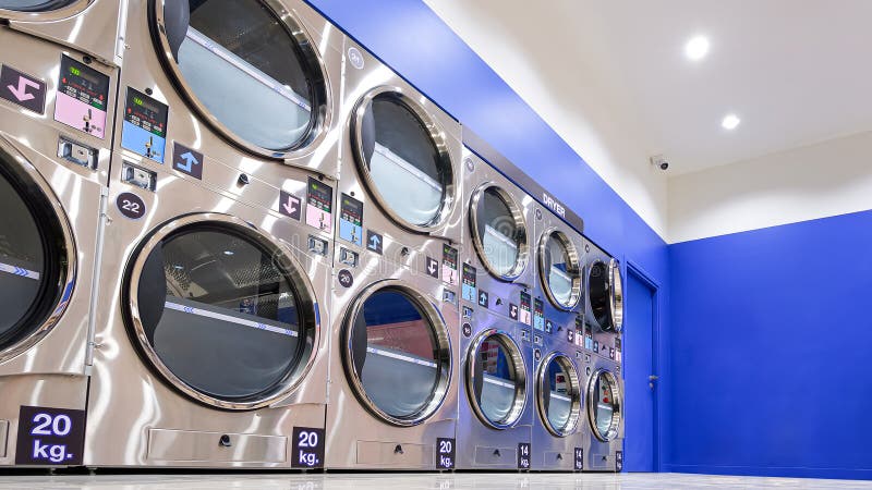 Row of Vending Washing Machines and Clothes Dryers Inside of Modern ...
