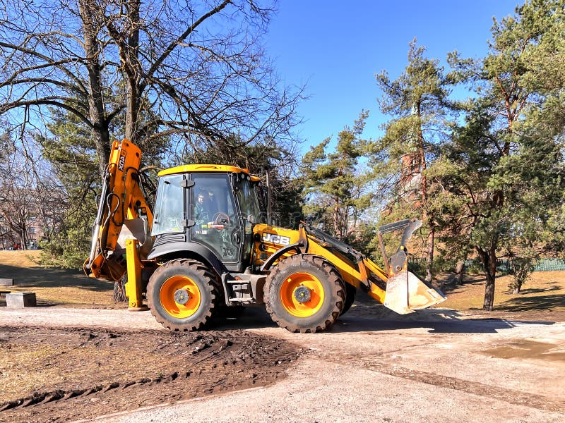 A Municipal Tractor Works in a City Park Clearing Paths after ...