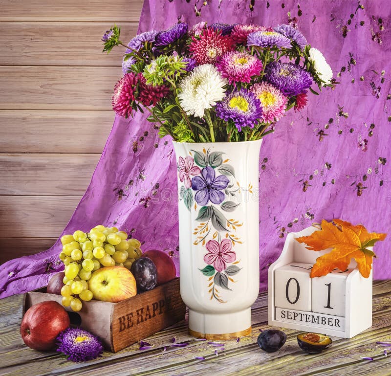 A Vase with a Bouquet of Autumn Aster Flowers, a Wooden Calendar with ...