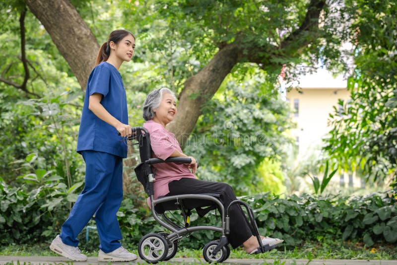 Elderly Woman in a Wheelchair Enjoying a Peaceful Stroll in the Park ...