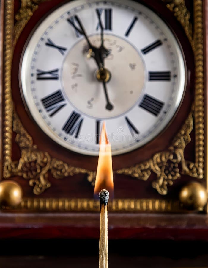 Old Clock with a Burning Match on the Background of the Wall Clock ...