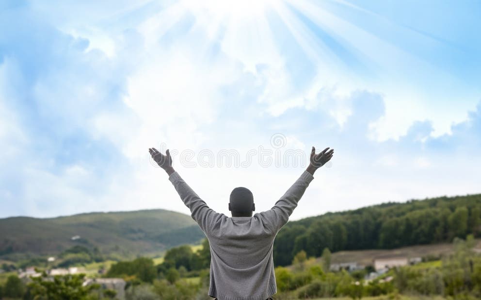 Praising the Lord. a Man with His Arms Raised To the Sky in ...