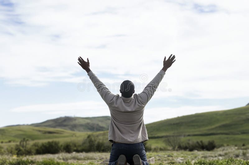 Praising the Lord. Back View of a Man with His Arms Raised To the Sky ...