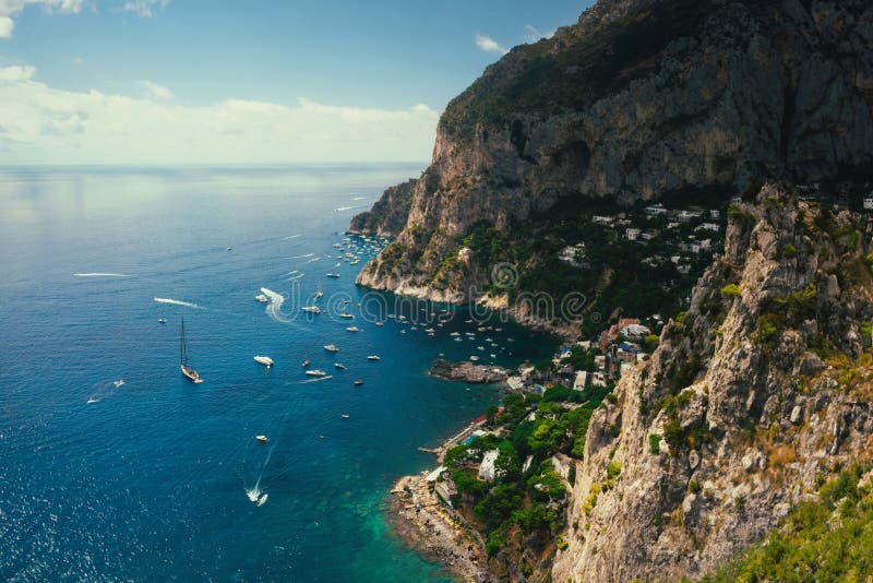 Panoramic View of Capri’s Rugged Cliffs and Deep Blue Waters with Boats ...
