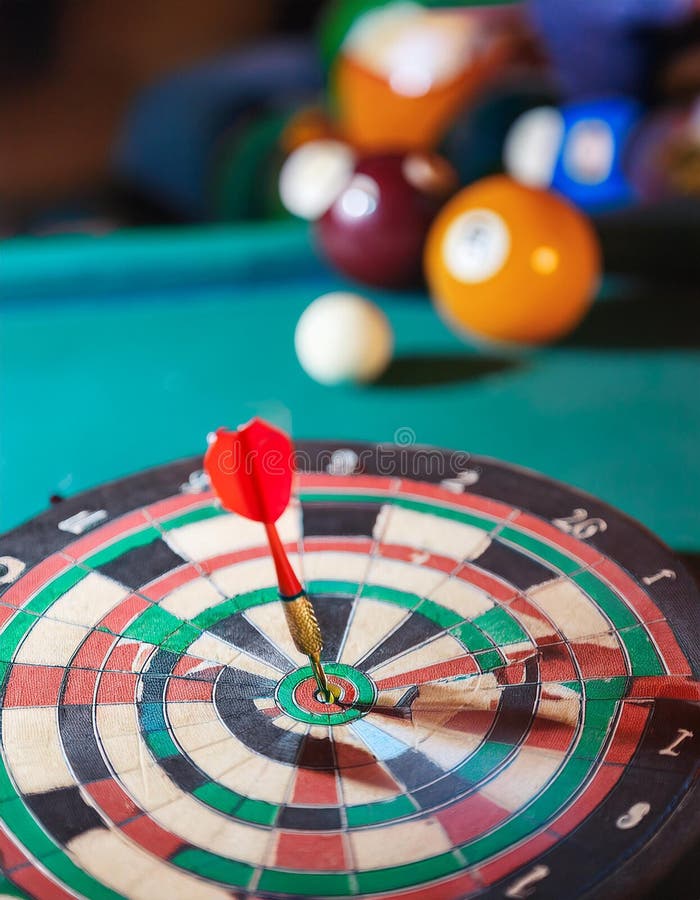 Games. Darts in a Dart Board with a Pool Game in the Background(shallow ...