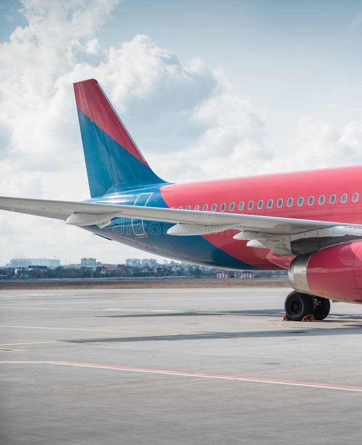 Tail Section of of Blush Pink Aircraft Parked on the Apron at the ...