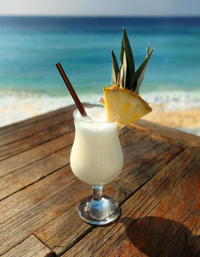 Tasty Pina Colada Cocktail on Wooden Table Near Ocean, Space for Text ...