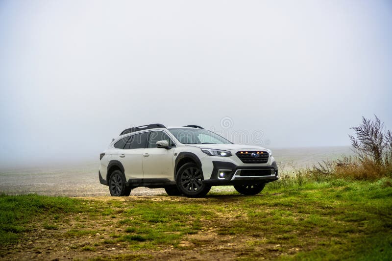 White Subaru Outback SUV in Autumn on a Meadow in the Fog Editorial ...