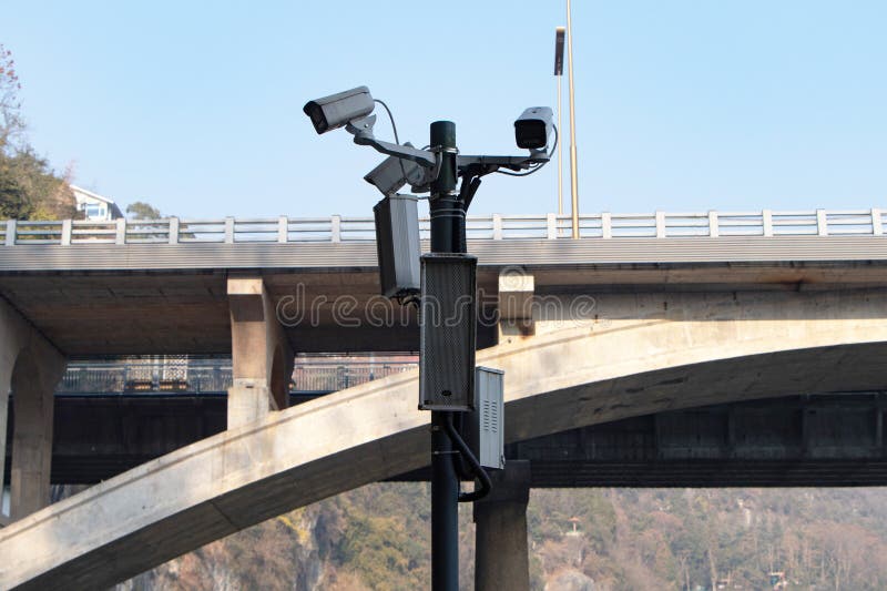 Closed-circuit Camera CCTV with Small Loudspeaker on Pole by Trees, Sky ...