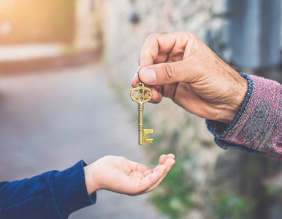 Hand of Father Giving Old Golden Key To Child - Inheritance Concept ...