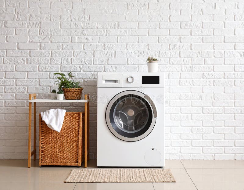 Modern Washing Machine Near Brick Wall in Empty Laundry Room Stock ...