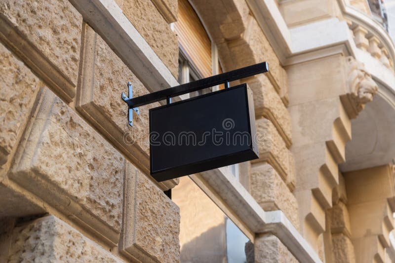 Black Rectangular Shop Sign on a Black City Facade. Sleek and Modern ...
