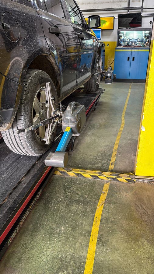 Vehicle on Lift with Wheel Alignment Equipment in Auto Repair Shop ...