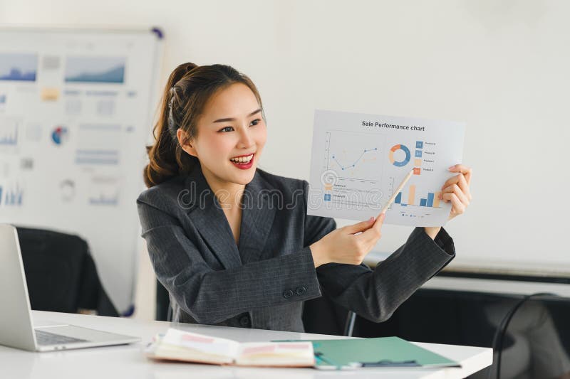 A Cheerful Young Professional Presents a Sales Performance Chart ...