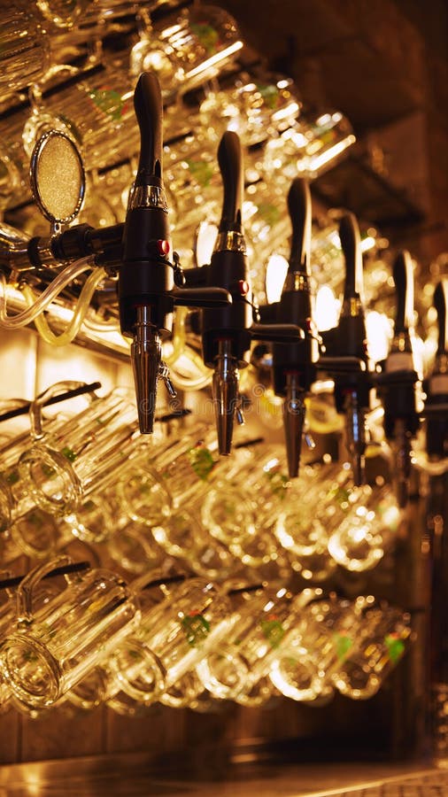 Close-up of Multiple Shiny Beer Taps with Handles, Set Against Blurred ...