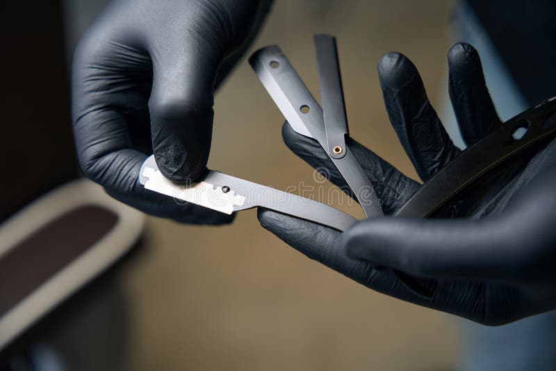 Barber Holding Razor for Shaving Beards in Barbershop Stock Photo ...