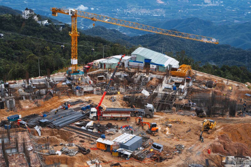 A Construction Site with a Crane and an Excavator. Development of a ...
