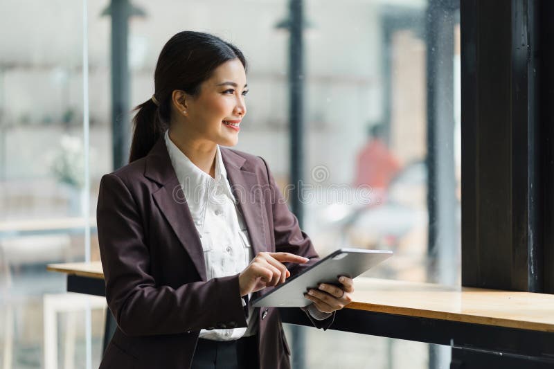 Corporate Executive with Digital Tablet Looking Out Window in Modern ...