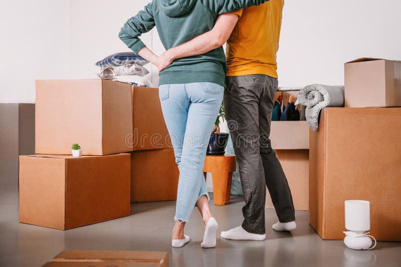 Couple is Standing and Hugging from the Back View, Looking at Moving ...