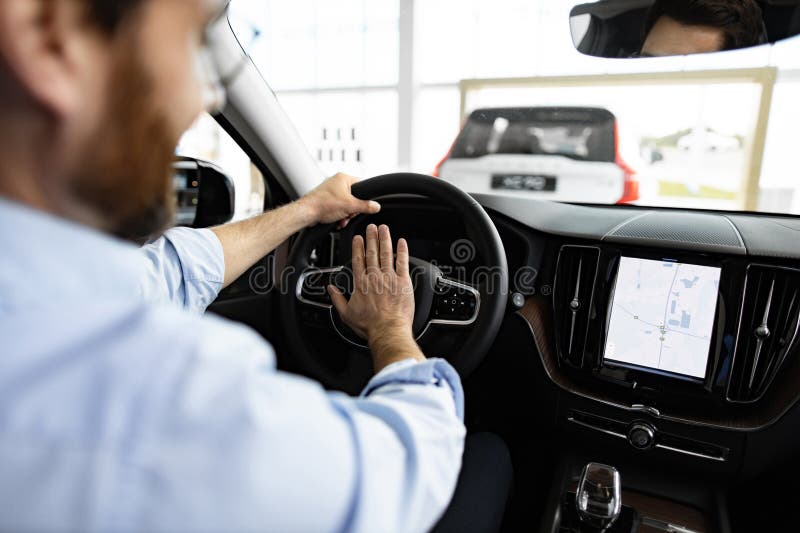 Businessman Drives Car Inside Dealership Showroom with Navigation ...