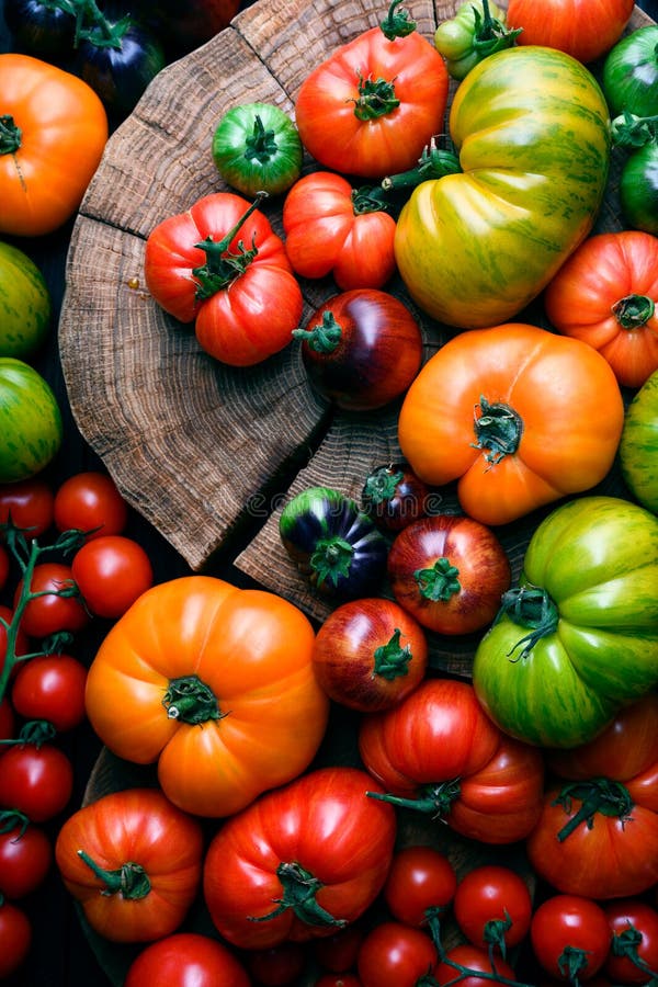 Different Sizes and Varieties Ripe Tomatoes on Wooden Cutting Board ...