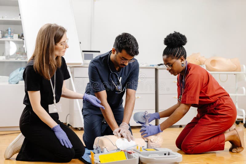 Diverse Group of Medical Students Practicing Cpr on a Medical Manikin ...