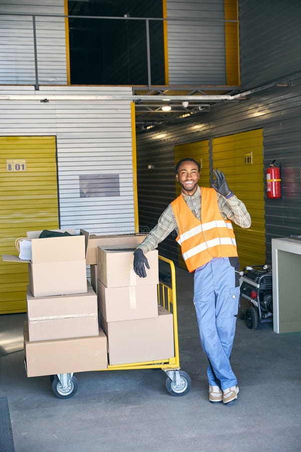 Cheerful Warehouse Loader Posing for Camera during Cargo Unloading ...