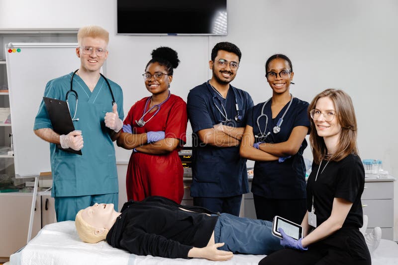 Group of Medical Students Learning Cardiopulmonary Resuscitation Techniques on a Dummy during ...