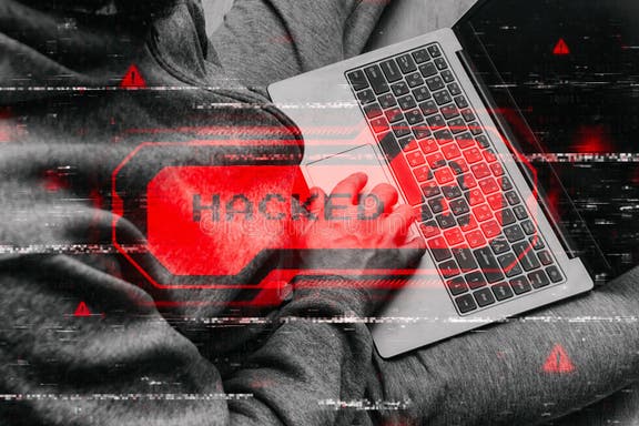 Hacker in a Hoodie Holds a Laptop with a Red HACKED Warning and Binary ...