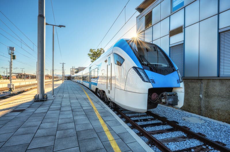High-speed Blue Passenger Train at Railway Station at Sunset Stock ...